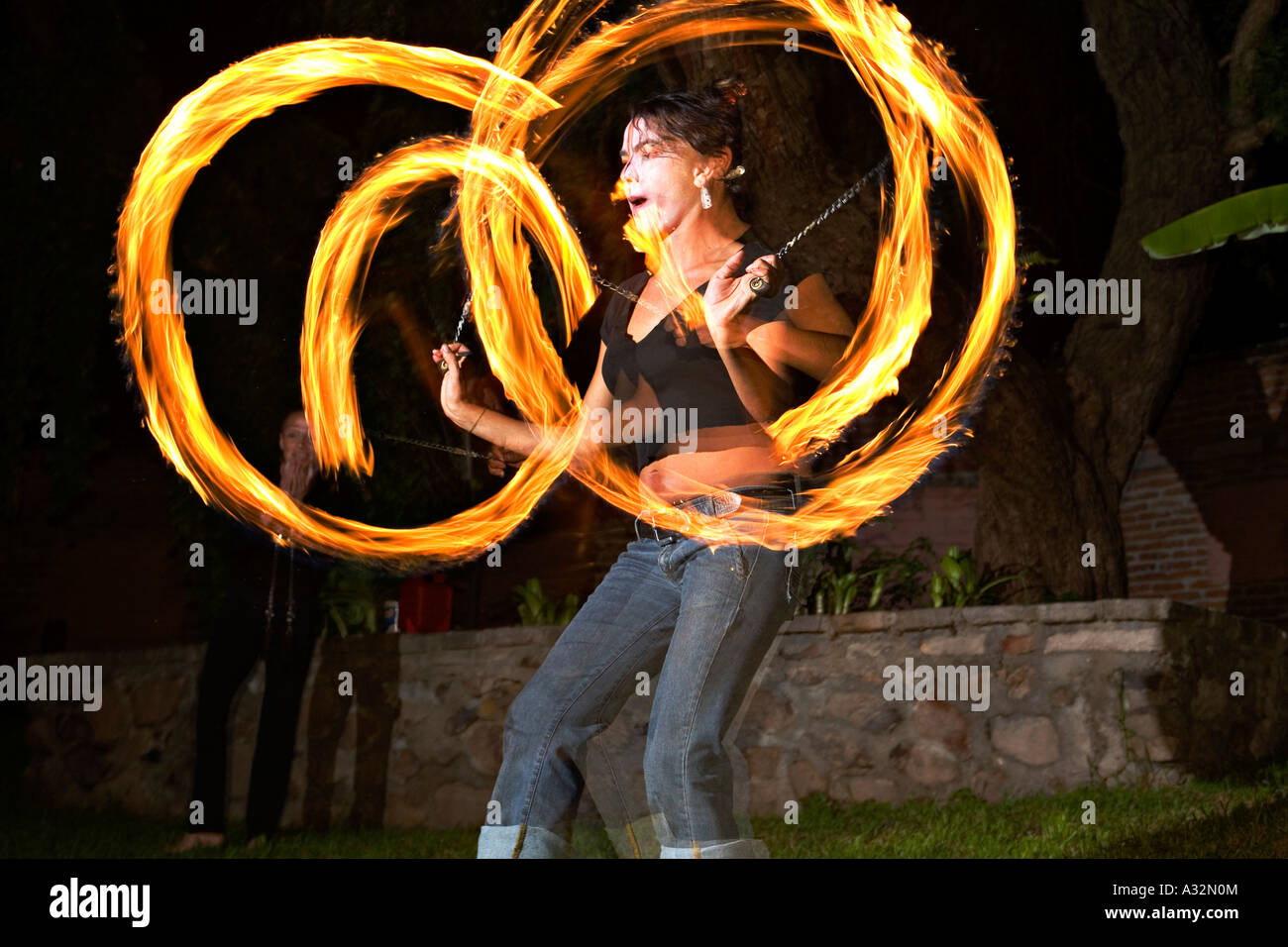 MEXICO San Miguel de Allende Woman fire dancing using poi circles of ...