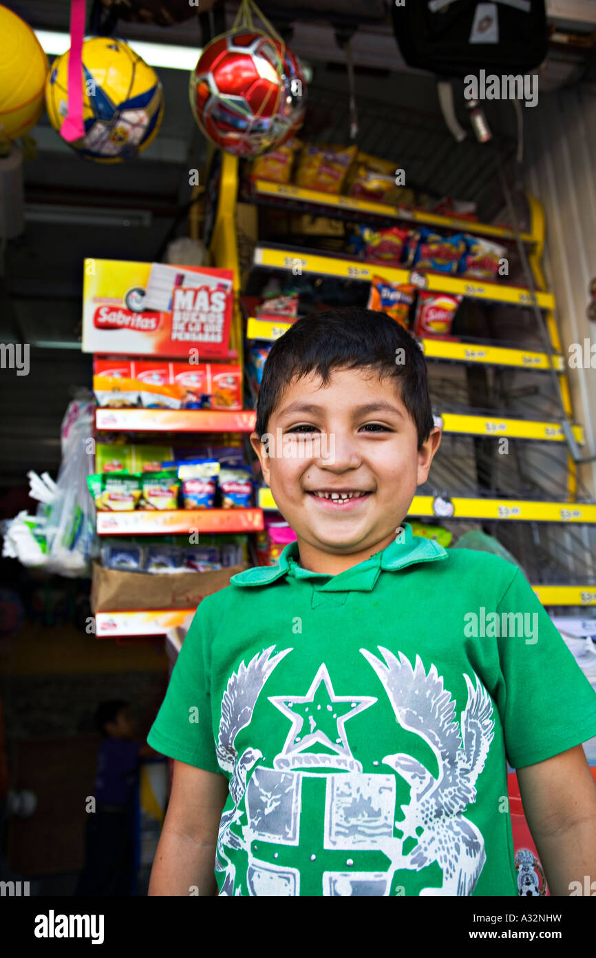 MEXICO San Miguel de Allende Young Mexican boy smile and stand in store ...