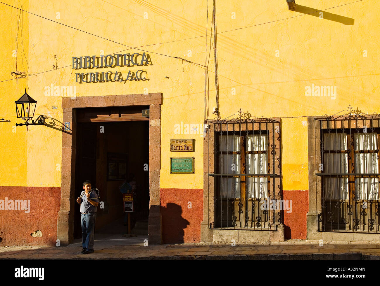 MEXICO San Miguel de Allende Boy with backpack stand outside entrance ...