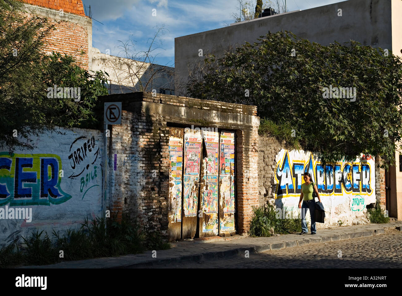 MEXICO San Miguel de Allende Young woman walk down sidewalk past white ...
