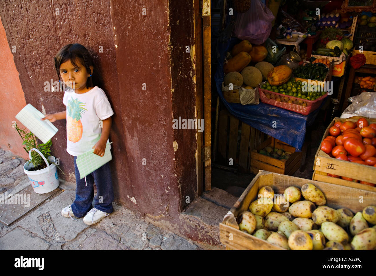 MEXICO San Miguel de Allende Shy young Mexican girl stand by doorway ...