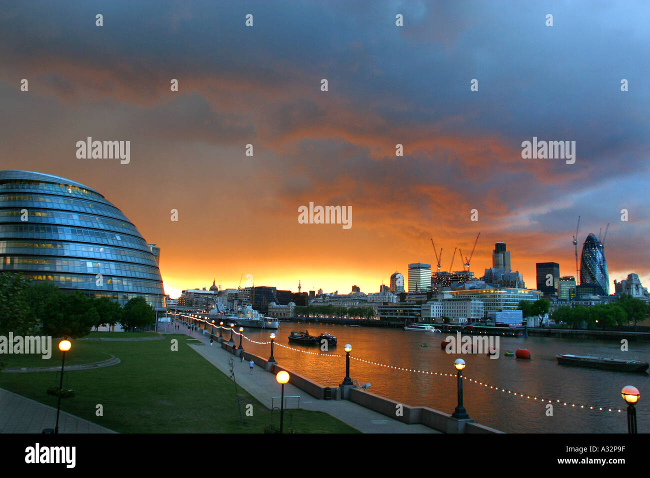 city hall and the city of london skyline seen across the river thames ...