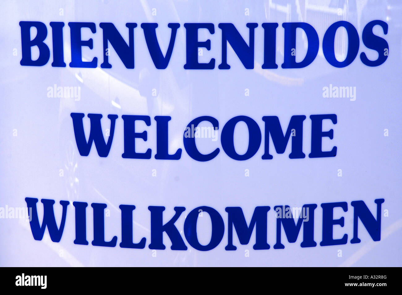 bienvenidos welcome willkommen sign white blue Stock Photo - Alamy