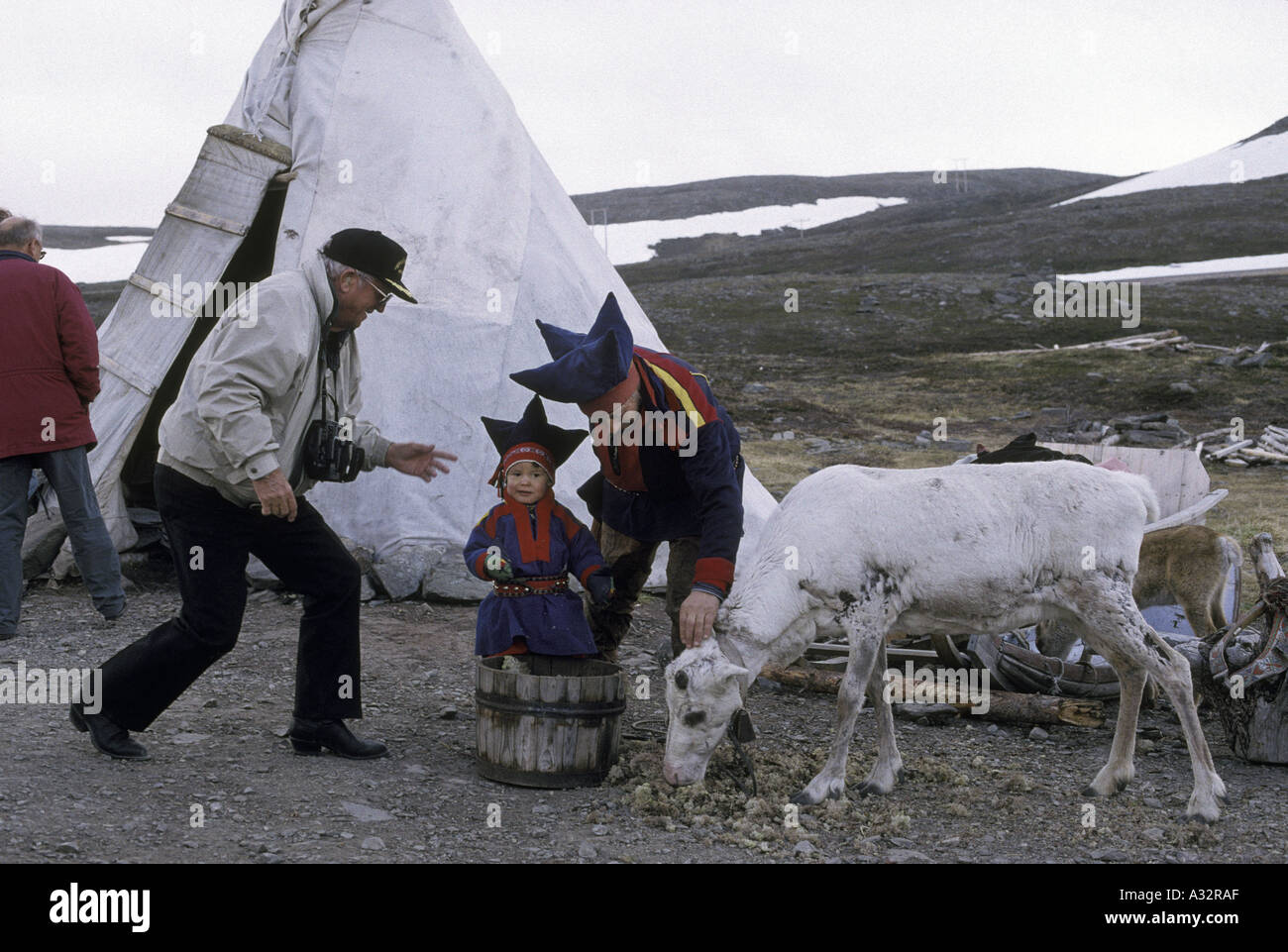 a sami family with a tourist in north cape Stock Photo - Alamy