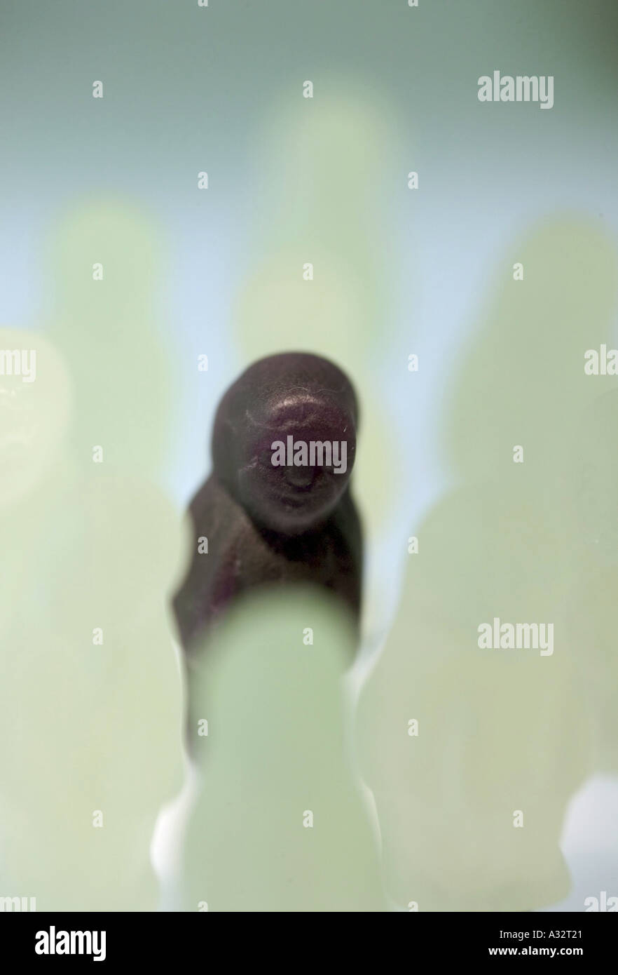 jelly babies one black jelly baby amongst a group of white Stock Photo ...