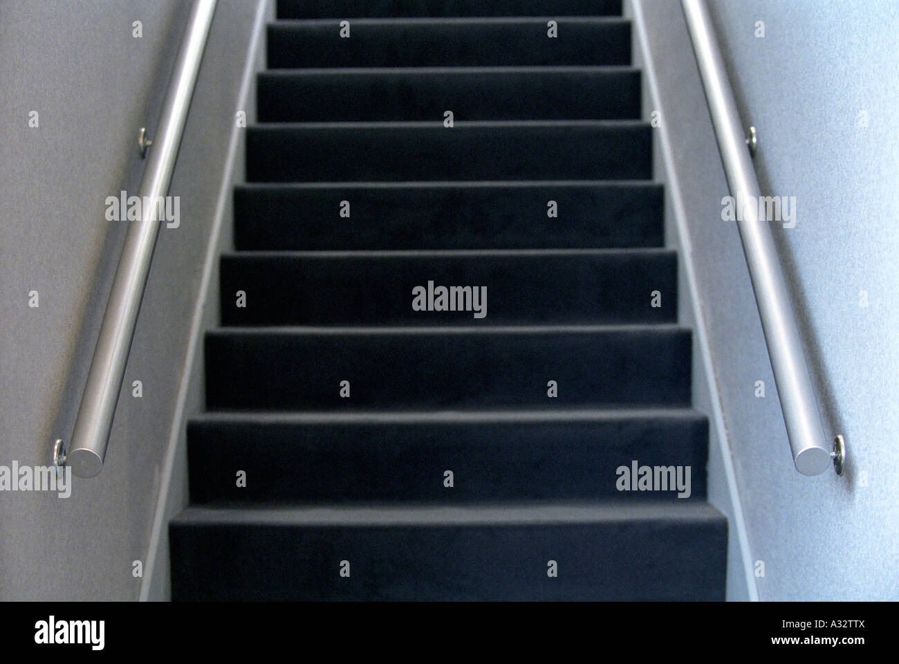 Steep stairs with stainless steel handrails Stock Photo - Alamy