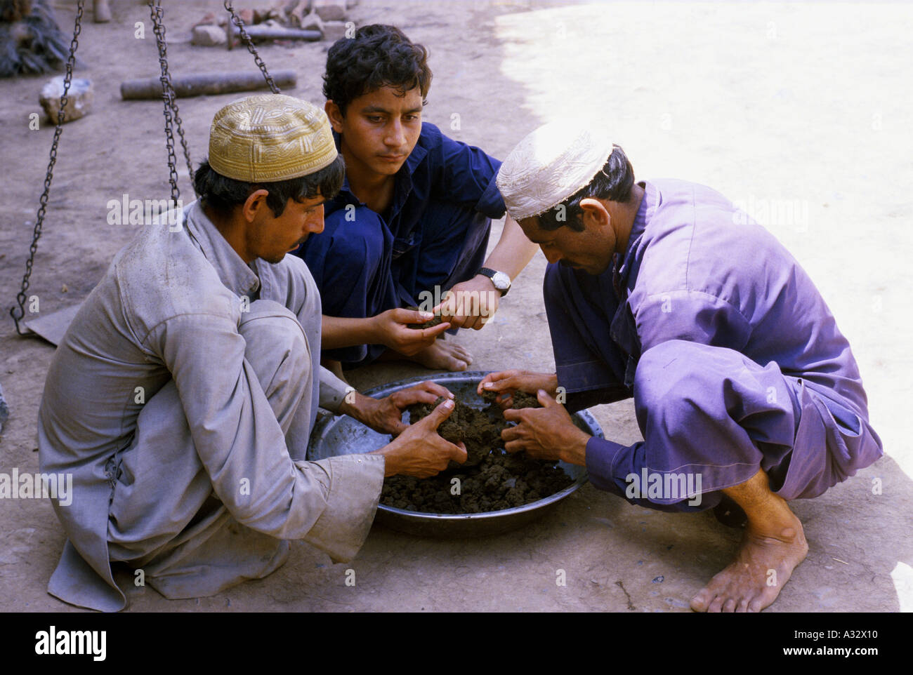 Cannabis resin: Men kneading cannabis resin in a hash factory, North ...