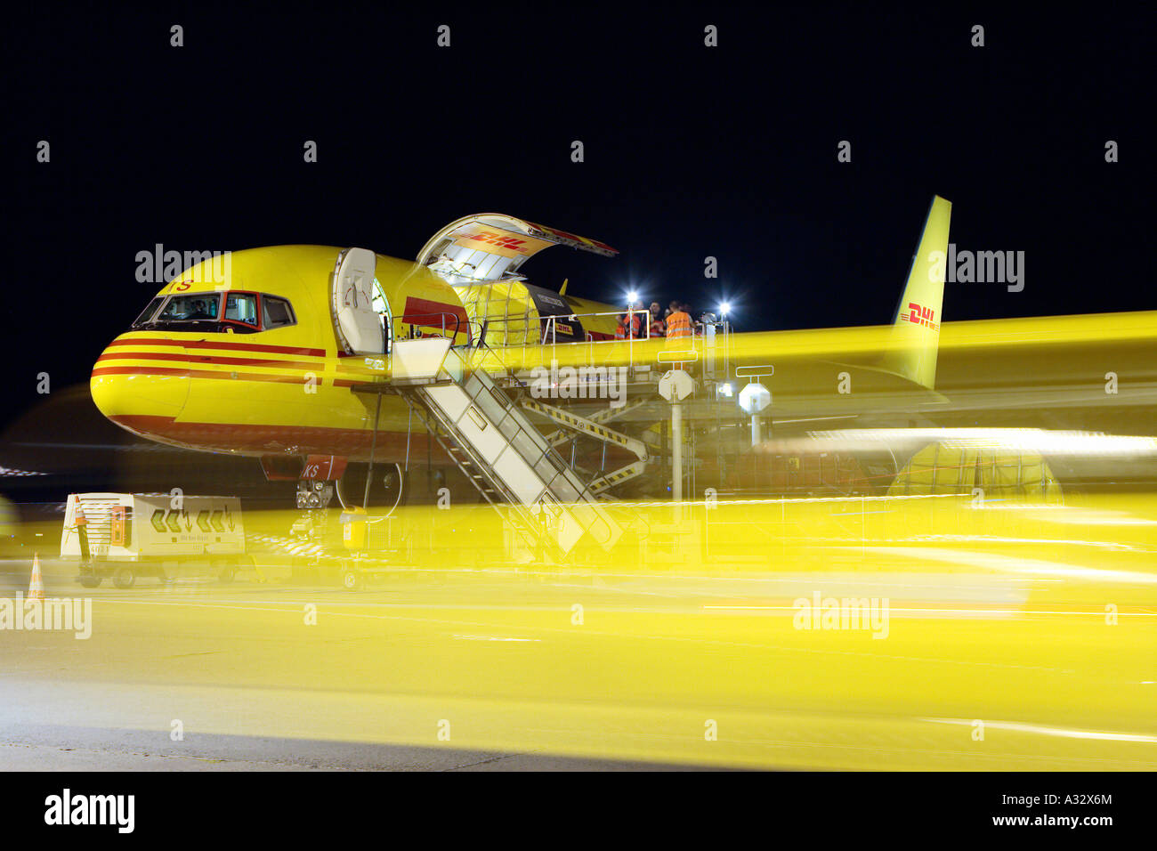A DHL cargo plane at the Cologne Bonn Airport at night, Germany Stock ...