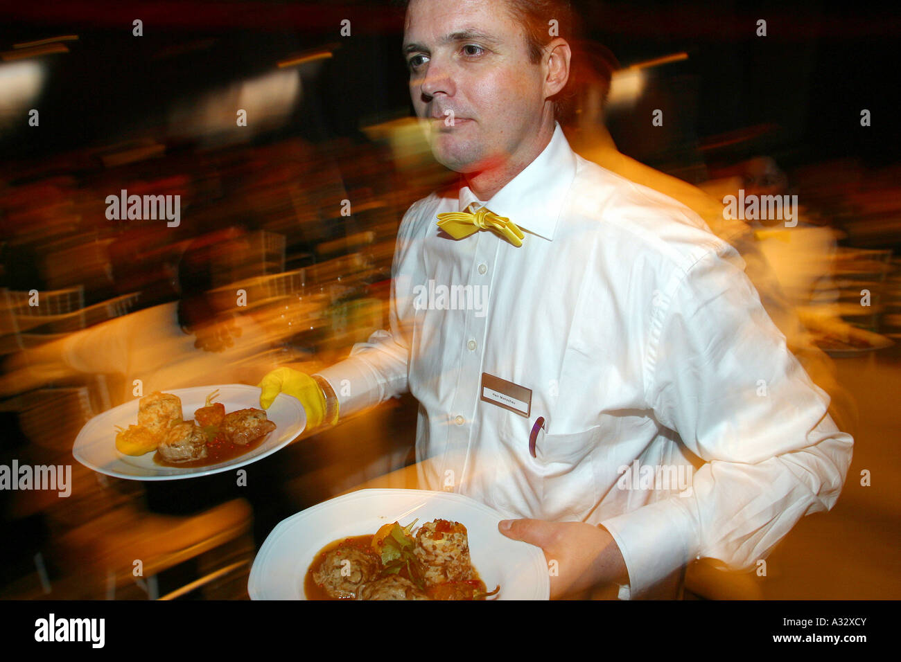 Waiter carrying food Stock Photo - Alamy