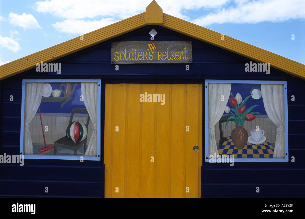 A traditional British seaside beach hut with painted windows ...