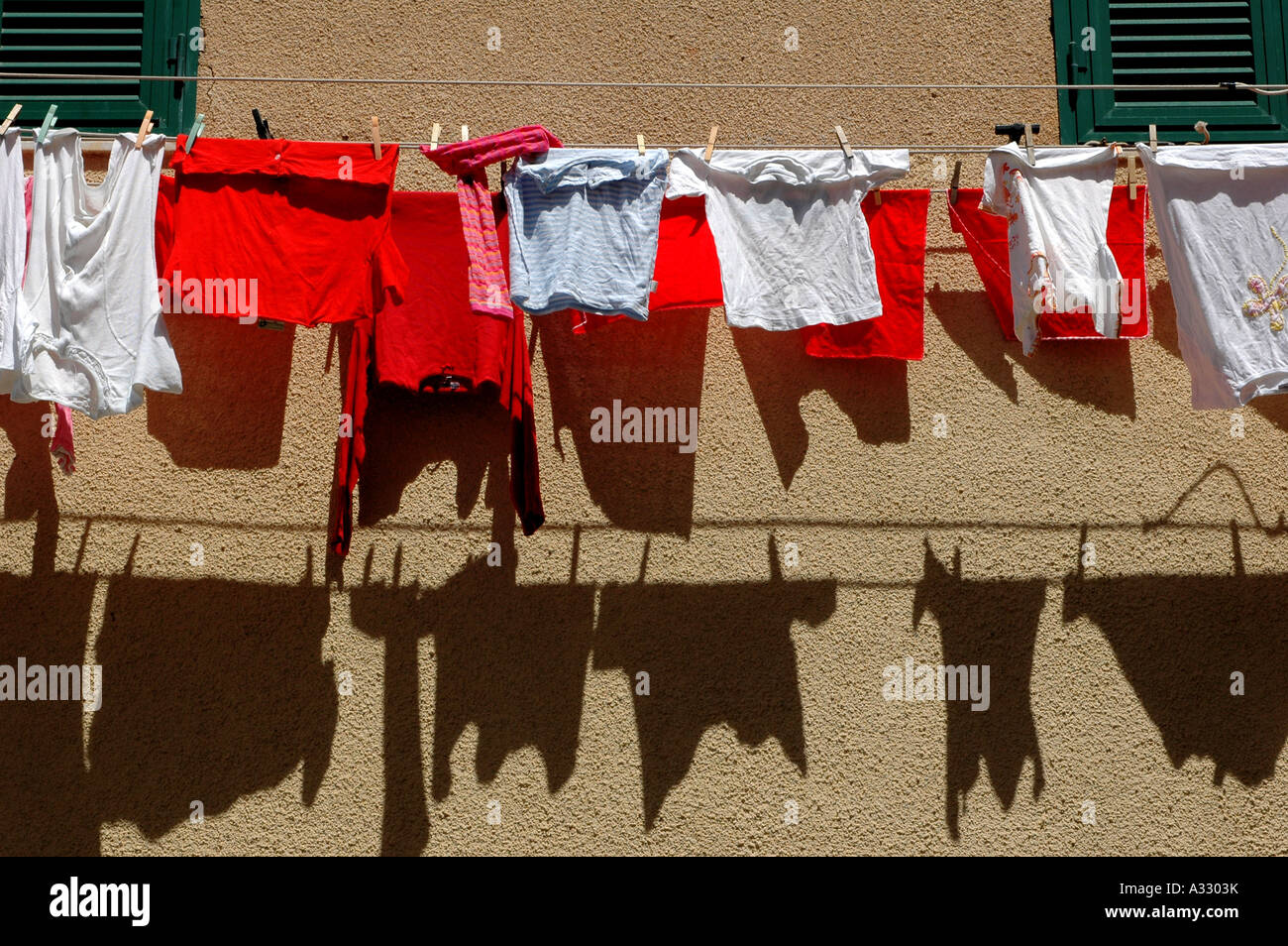 Colourful washing on the line outside a house in Alghero Sardina Italy ...