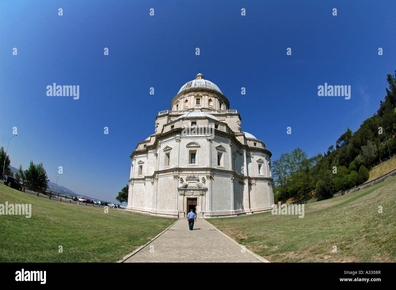 Man walking into the church of Santa Maria della Consolazione in Todi ...