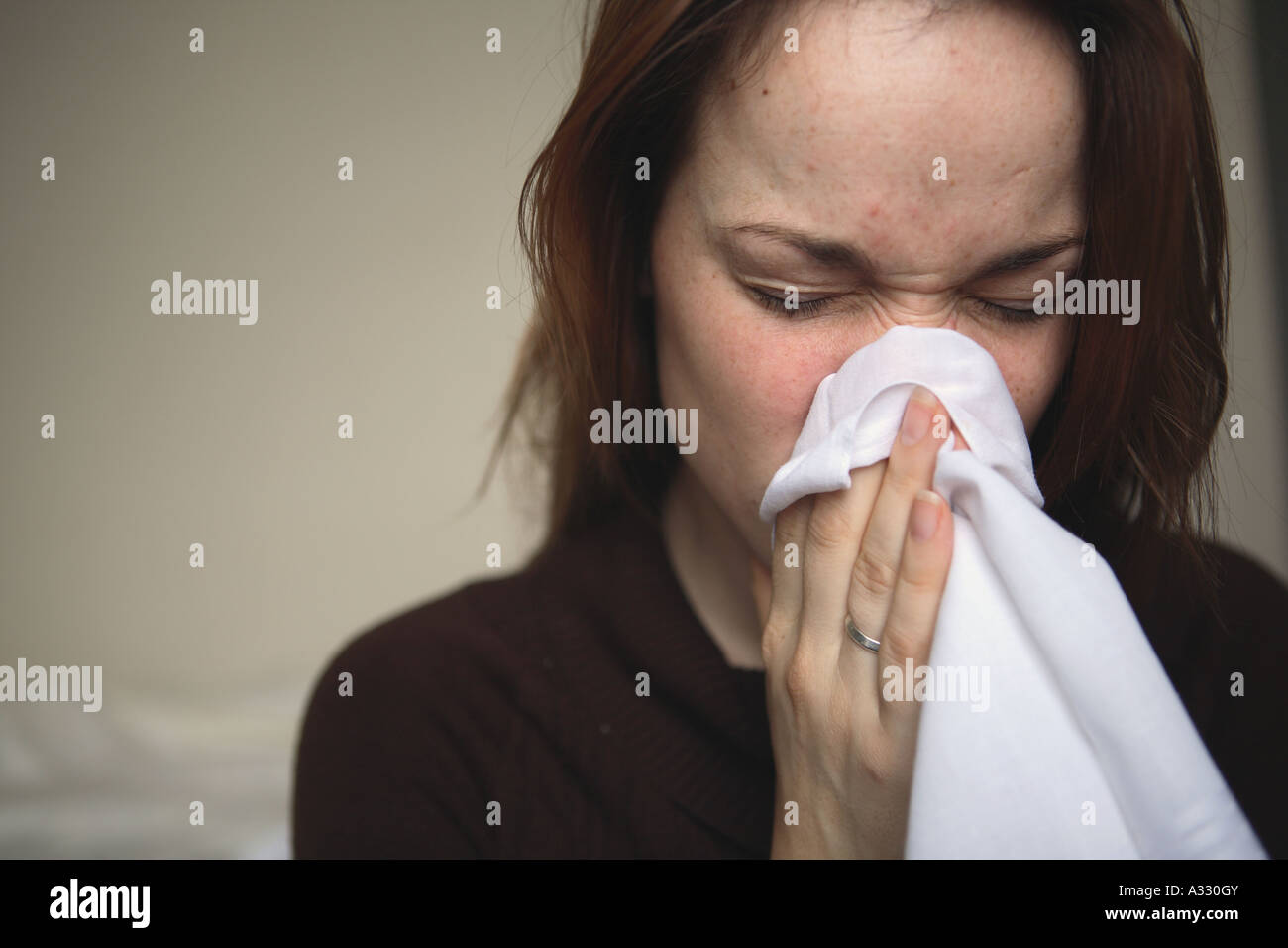 Female with cold/flu sneezing in her into a cloth handkerchief Stock ...