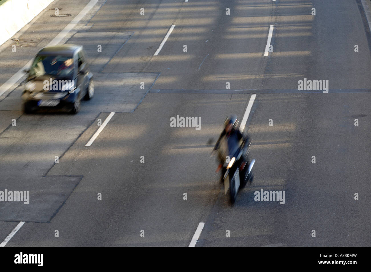 Speeding car and motorcycle on a freeway Stock Photo - Alamy