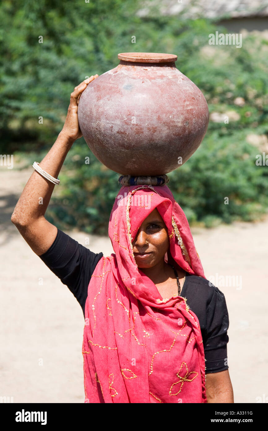 Local Hindu woman carrying a pot on her head in Rajasthan India Stock ...
