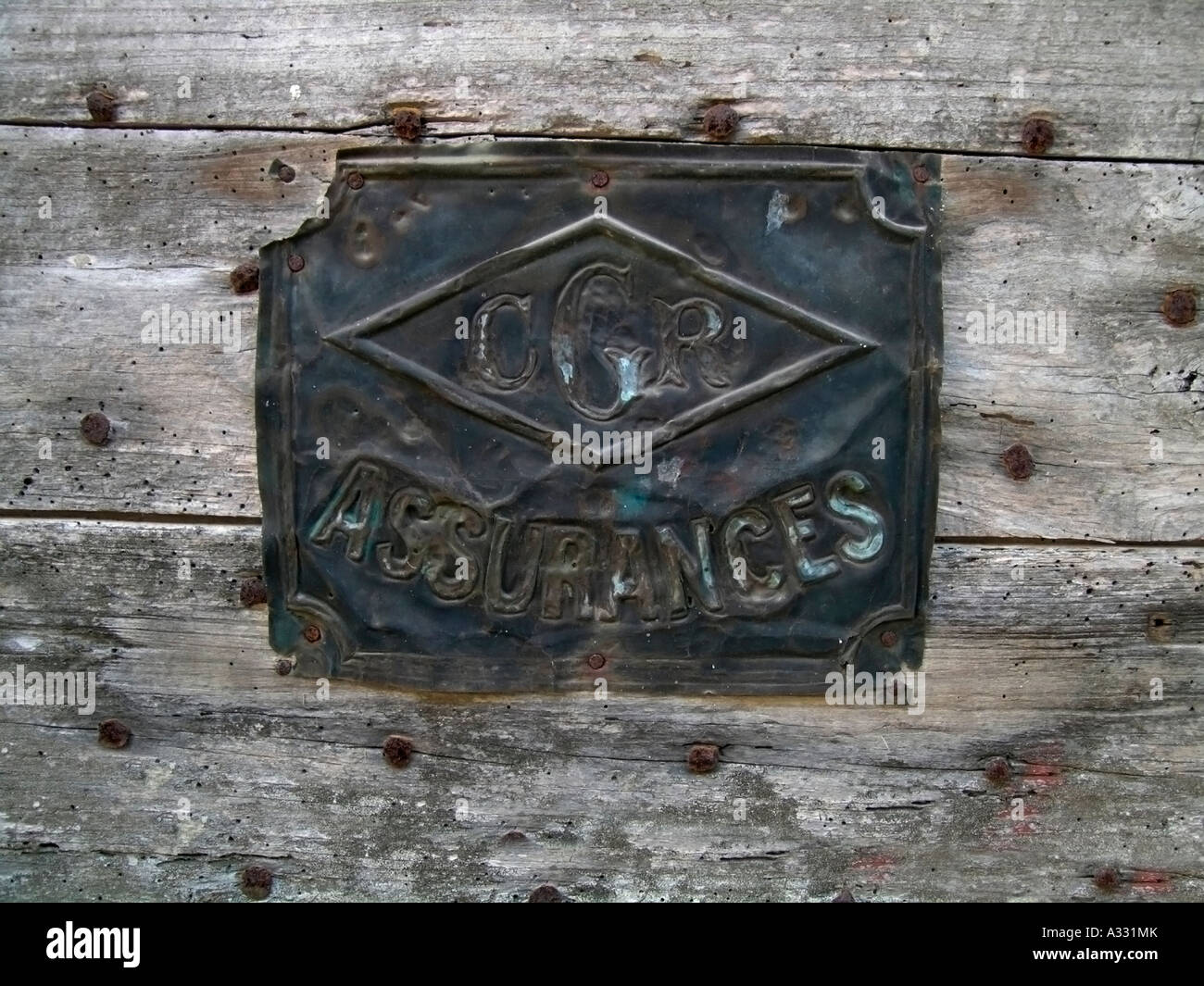 old rusty advertising sign for an insurance assurance company on a old ...