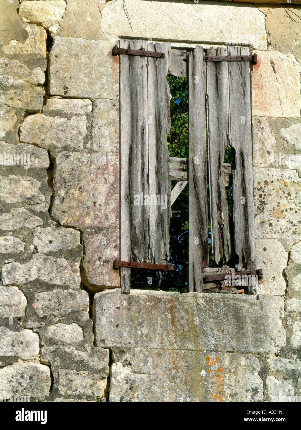 remains of a house broken wall with a window and broken down cutters ...
