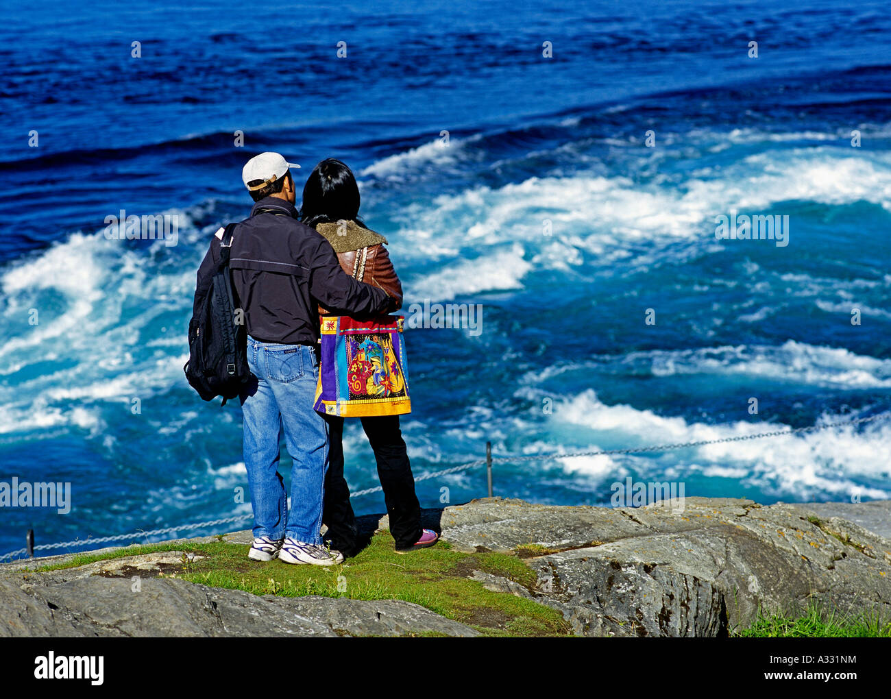 A tourist couple watching the Tidal Current, Bodo, Norway Stock Photo ...
