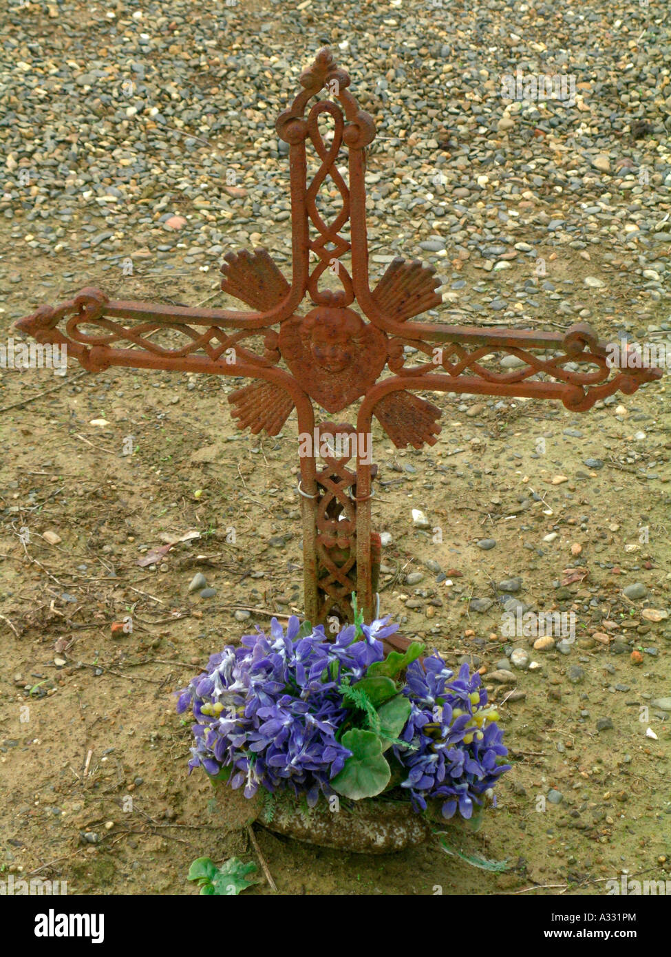 old iron grave cross on a grave in an old cemetery graveyard Stock ...