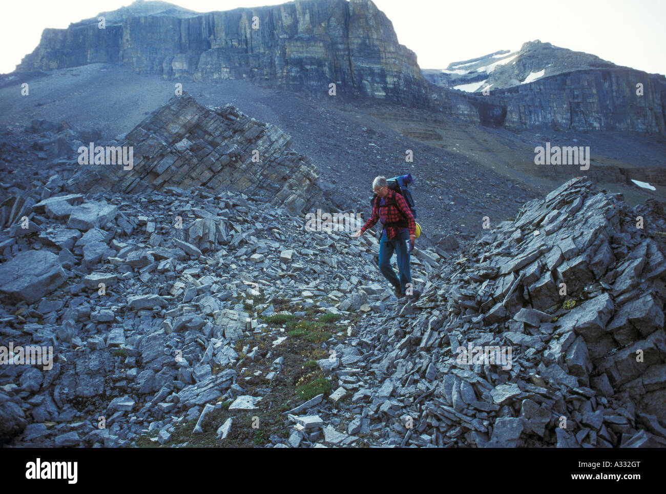 Banff National Park Alberta Canada A backpacker hiking on talus through ...