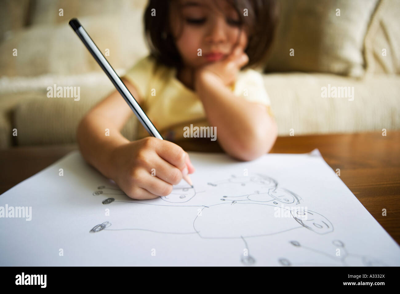 Pretty girl draws pictures with pencil and paper Stock Photo - Alamy