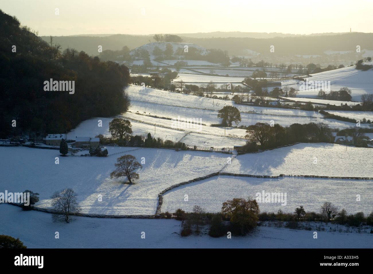 Early winter snow on the Cotswold escarpment below Coaley Wood towards ...
