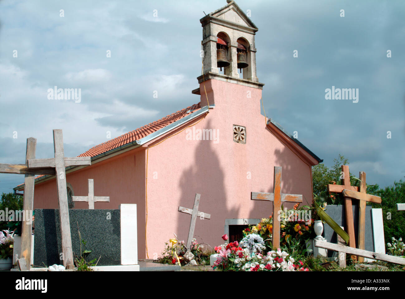 little chapel with a graveyard with simple wooden crosses on graves in ...
