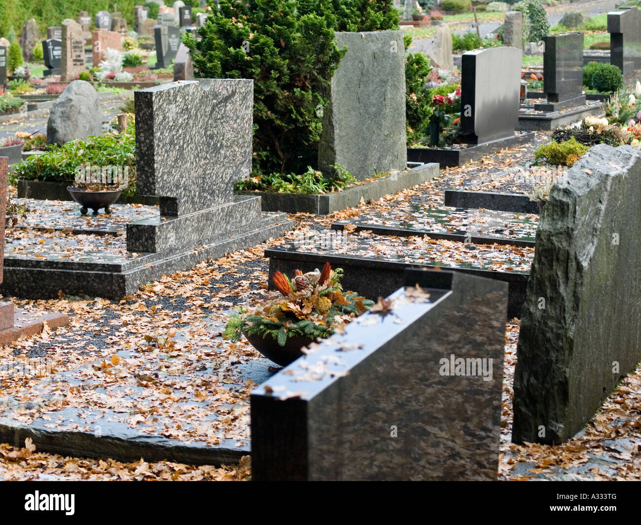typical German graveyard cemetry with rows of graves and polished ...