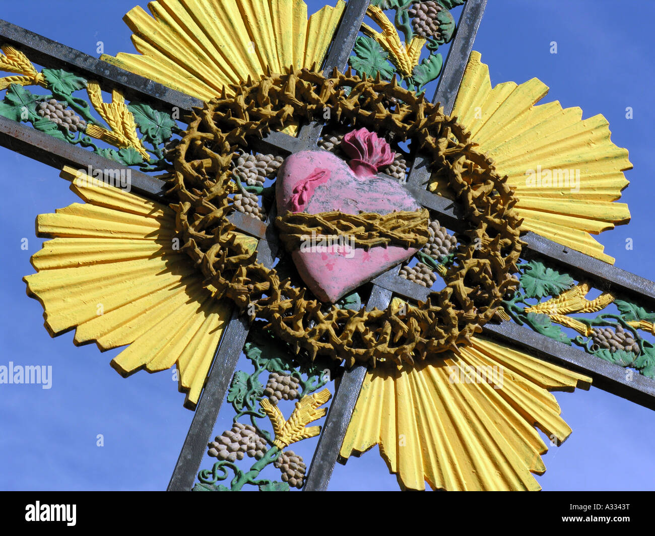 coloured cross with a heart in front of blue sky Stock Photo - Alamy