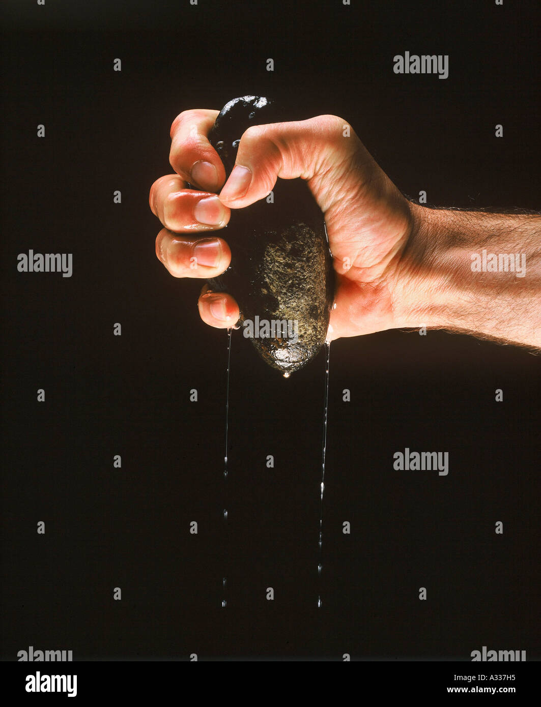 Squeezing liquid from a sponge B8D Stock Photo - Alamy