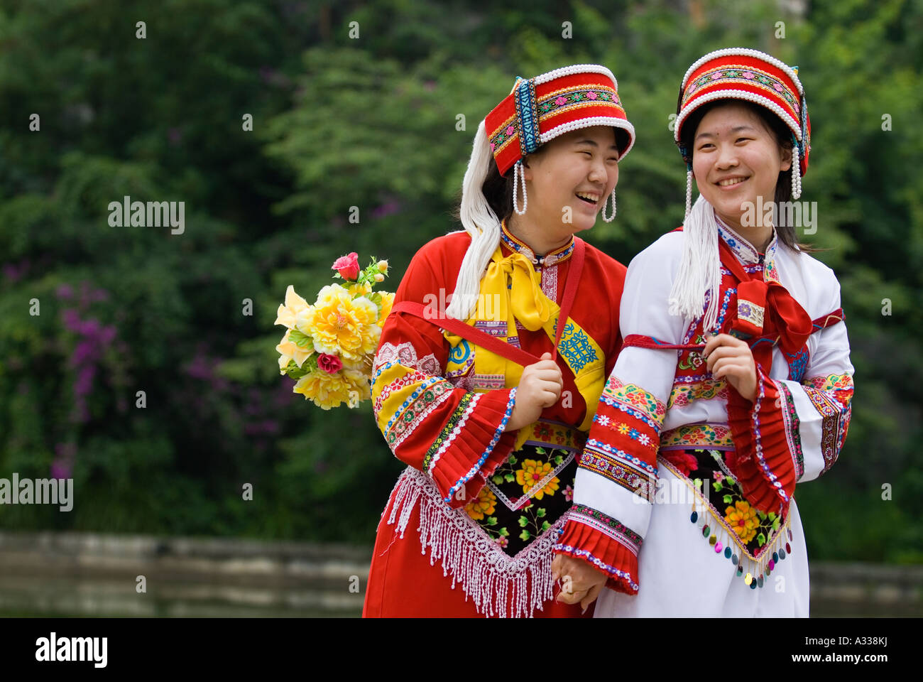 Chinese tourists visiting Stone Forest dress in costumes of the Sani ...
