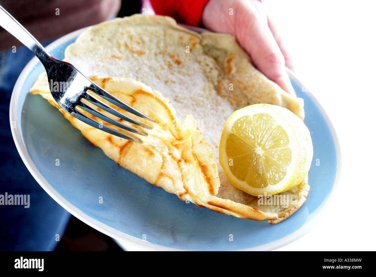 Young Woman Folding a Pancake Model Released Stock Photo - Alamy