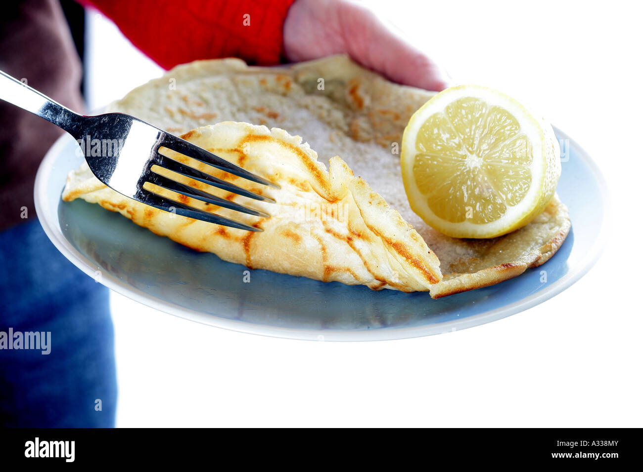Young Woman Folding a Pancake Model Released Stock Photo - Alamy