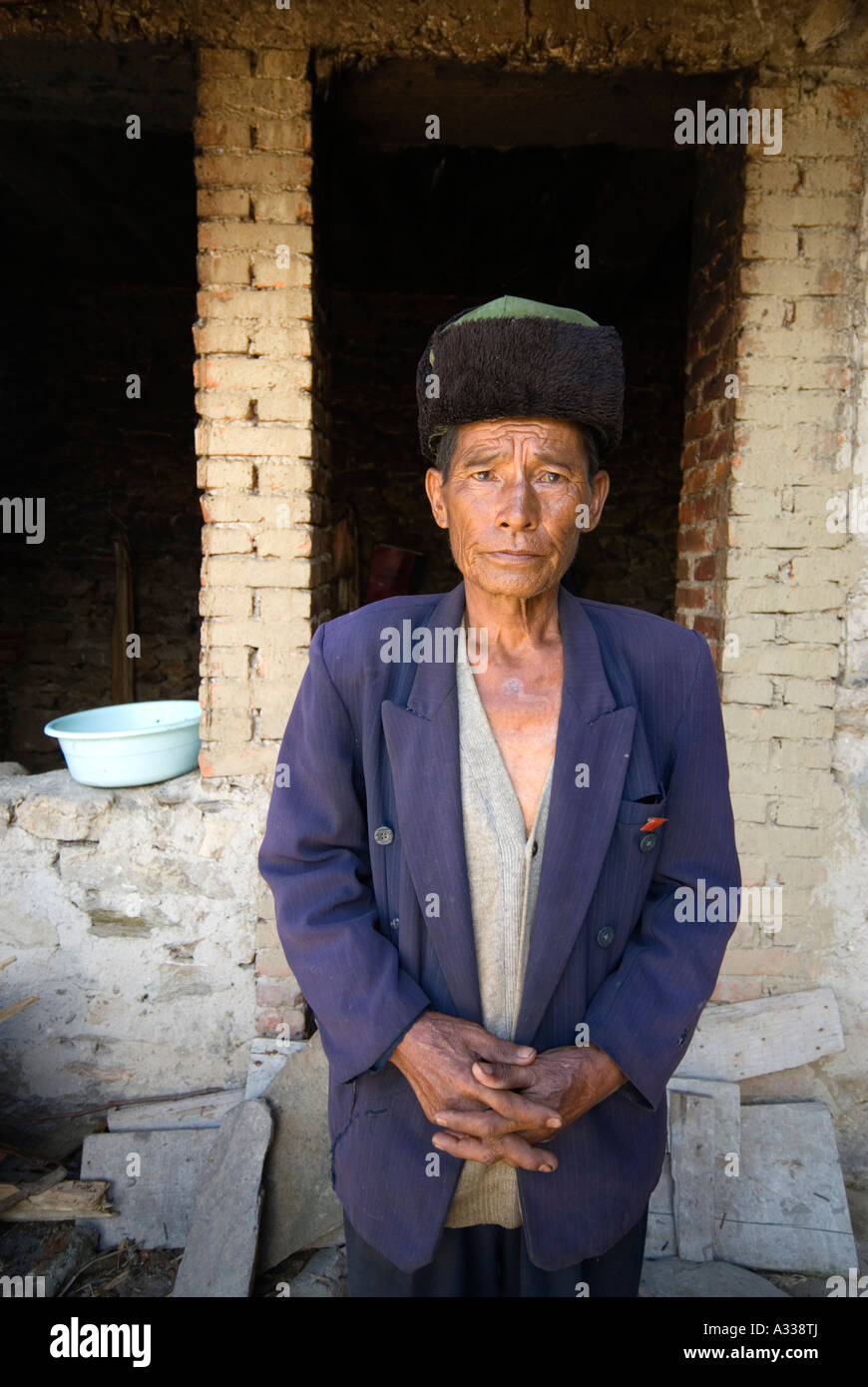 Elderly villager proudly displays Communist Party member red lapel pin ...