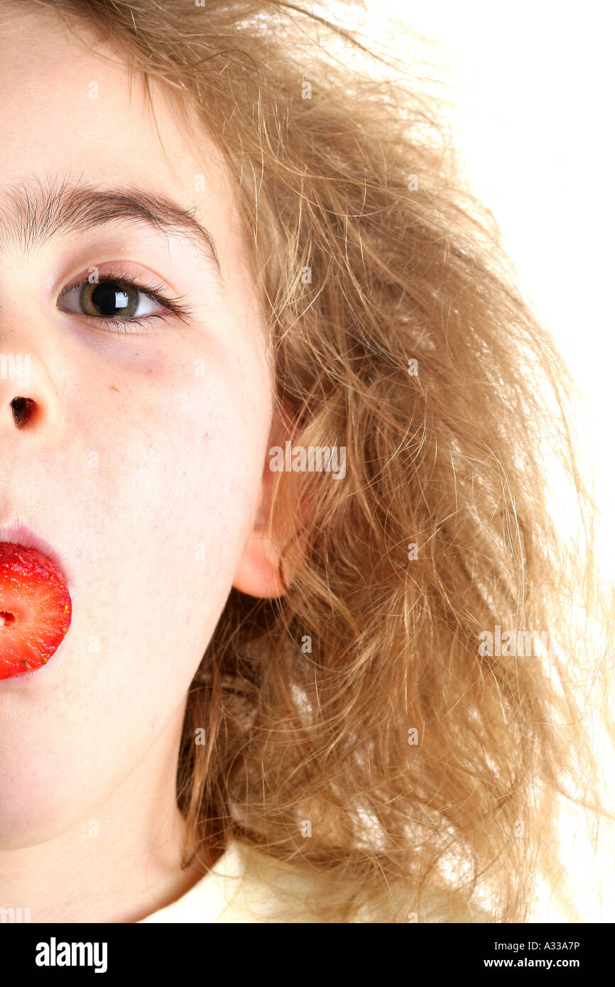 Young Girl Eating A Strawberry Model Released Stock Photo - Alamy