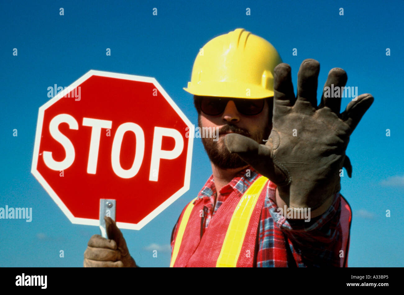 Workman holding stop sign hi-res stock photography and images - Alamy