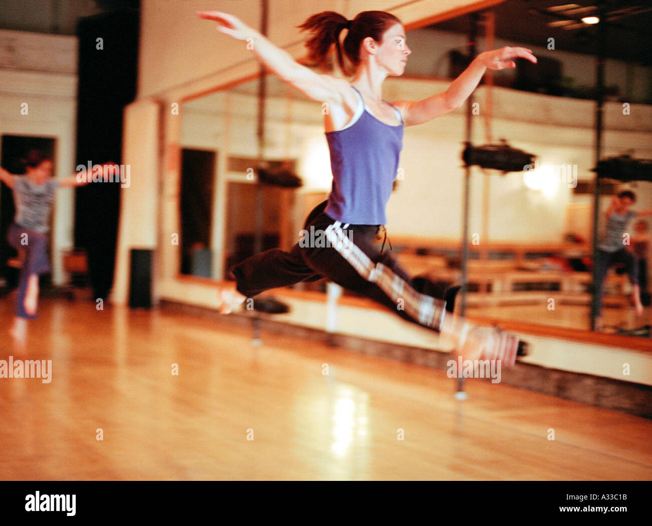 Student performing a leap in ballet class Stock Photo - Alamy