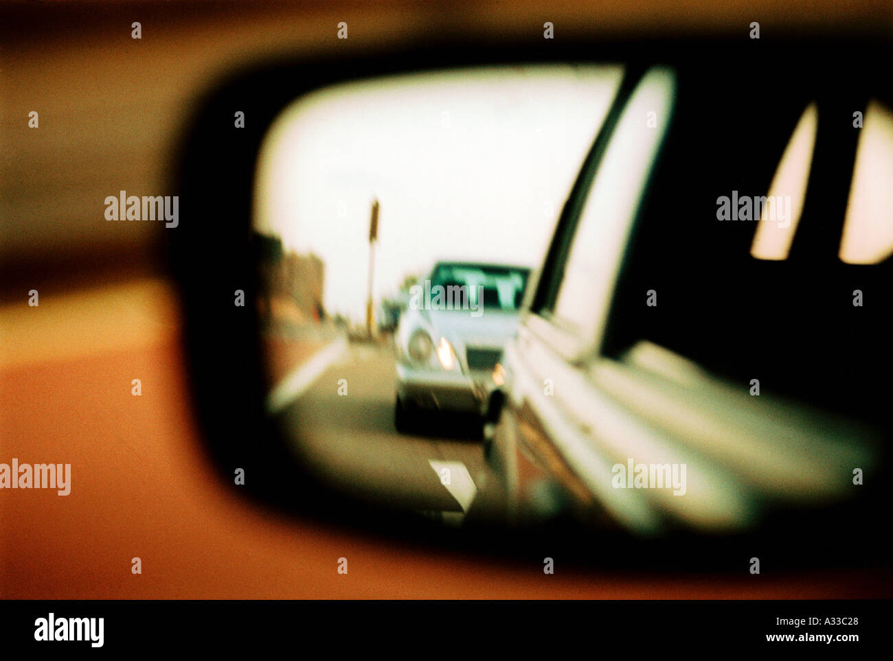 Car chase-speeding car in rear view mirror Stock Photo - Alamy