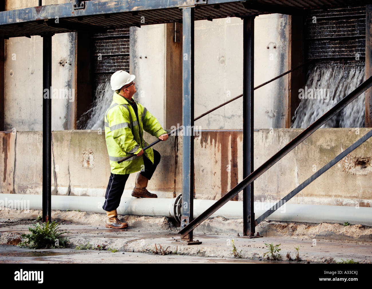 Workman adjusting the sluice gates of the waste ash washing pits at a ...