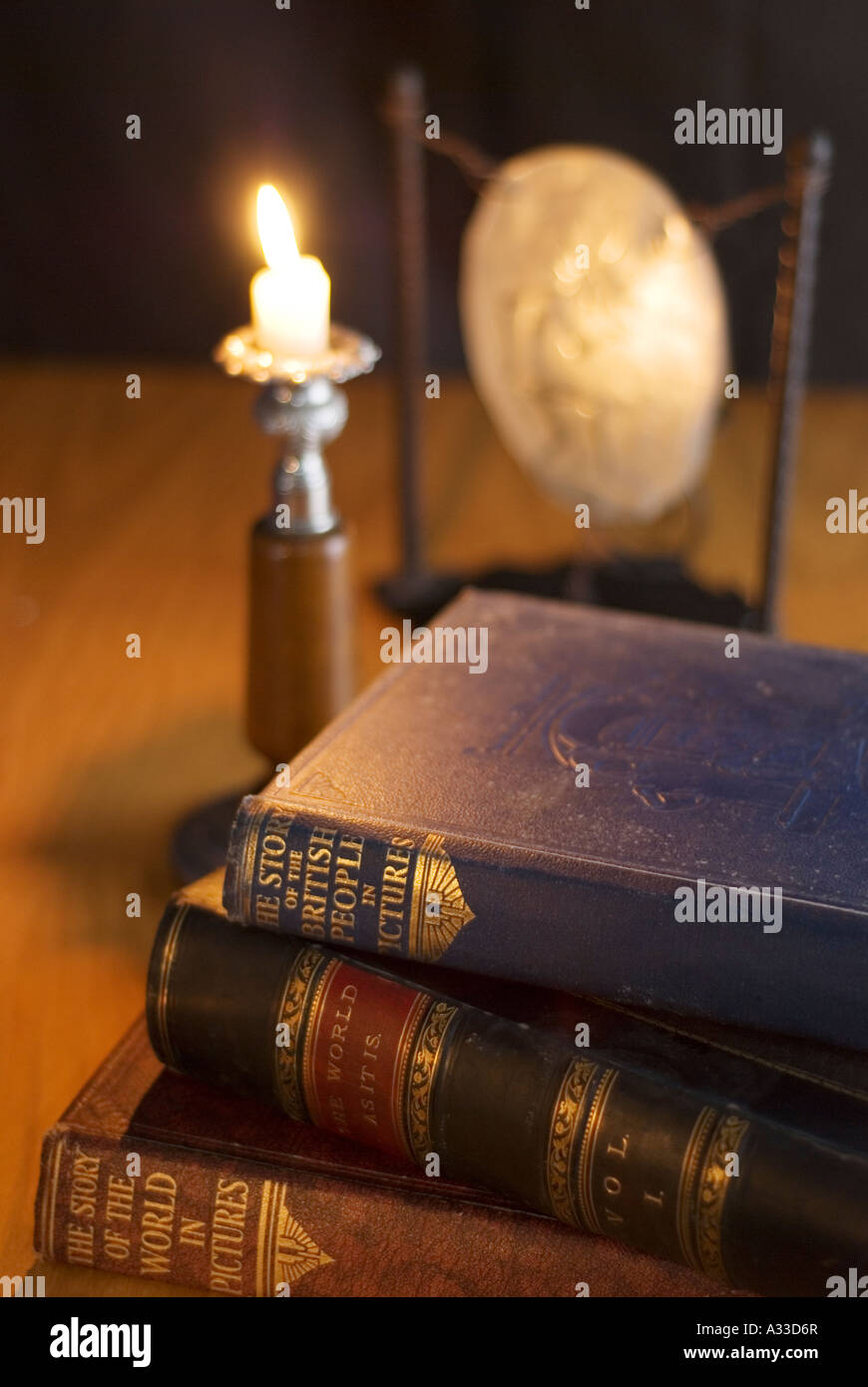 Books and candlestick Stock Photo - Alamy