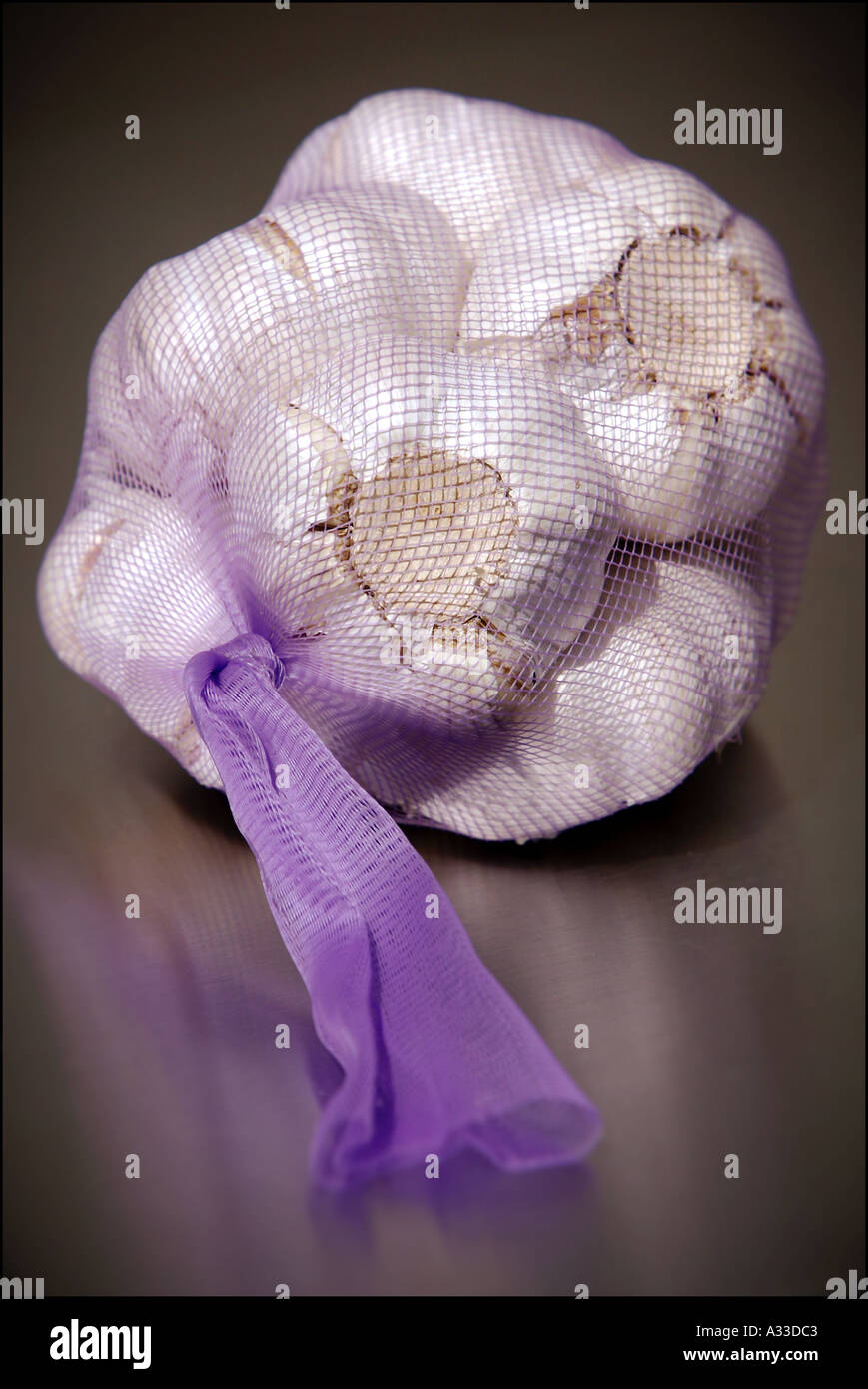 Garlic in string bag Stock Photo - Alamy