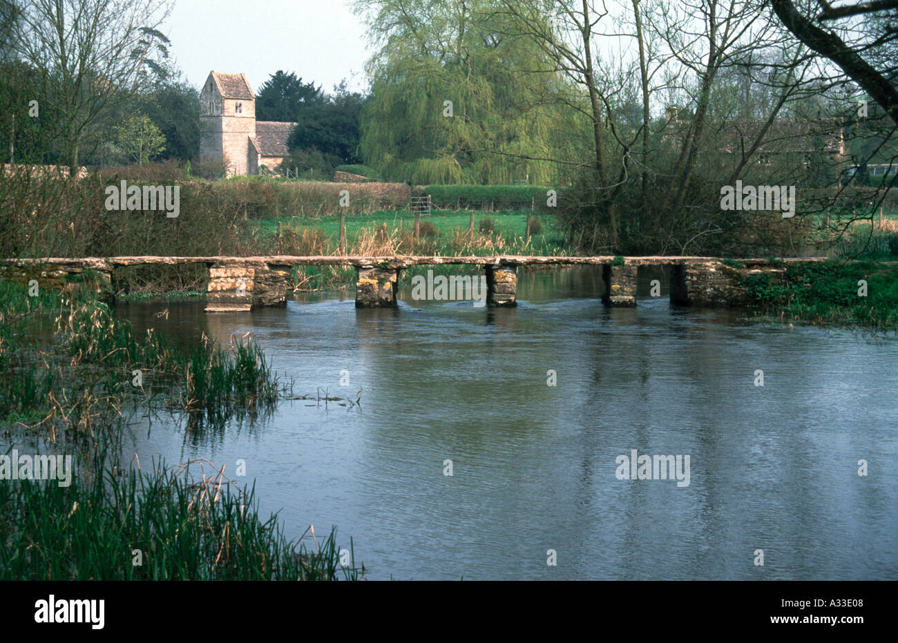 The Ancient clapper bridge, And, River Leach at Eastleach ...