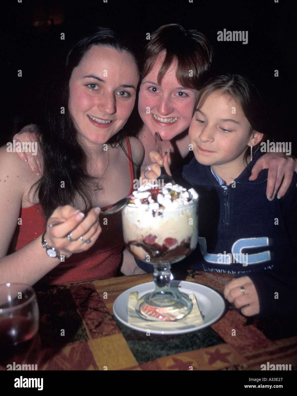Three girls eating ice cream Stock Photo - Alamy