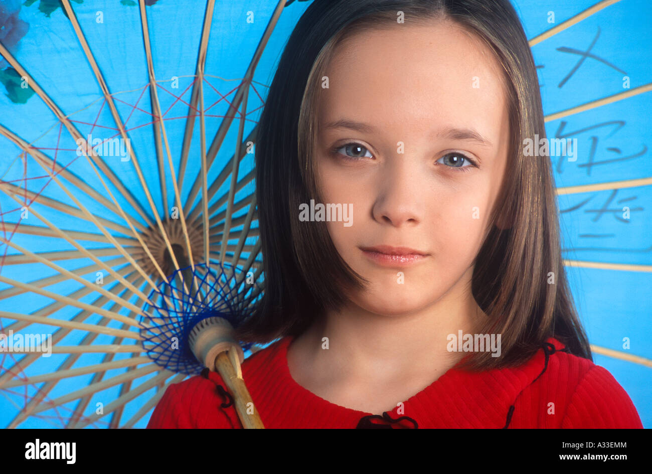 A Young girl holding parasol umbrella Stock Photo - Alamy