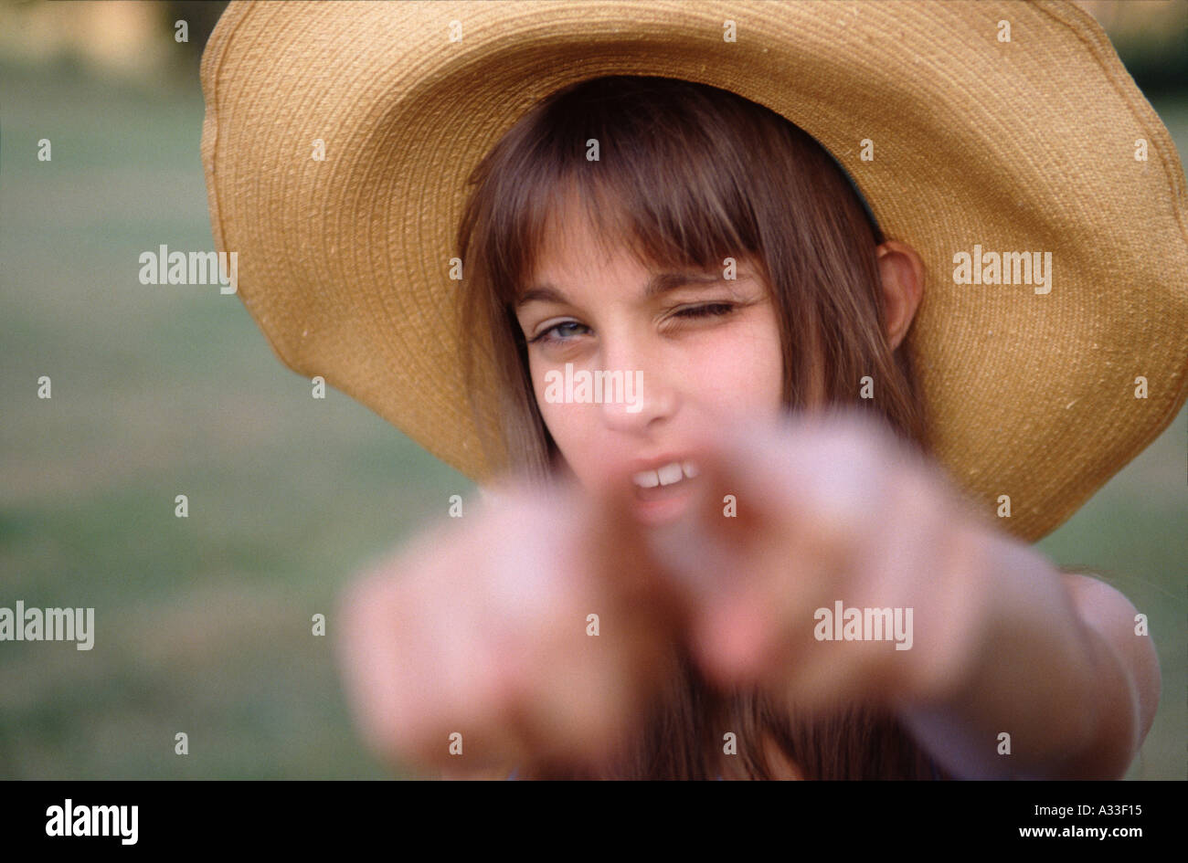 girl wearing a large hat pointing at viewer Stock Photo - Alamy