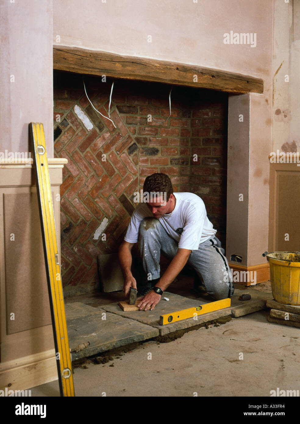Builder building fireplace Stock Photo - Alamy