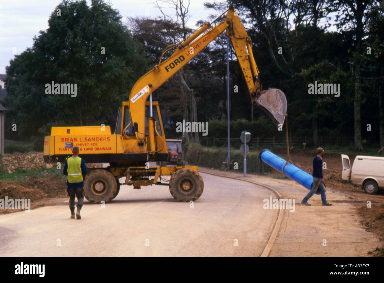 Digger crossing the road Stock Photo - Alamy