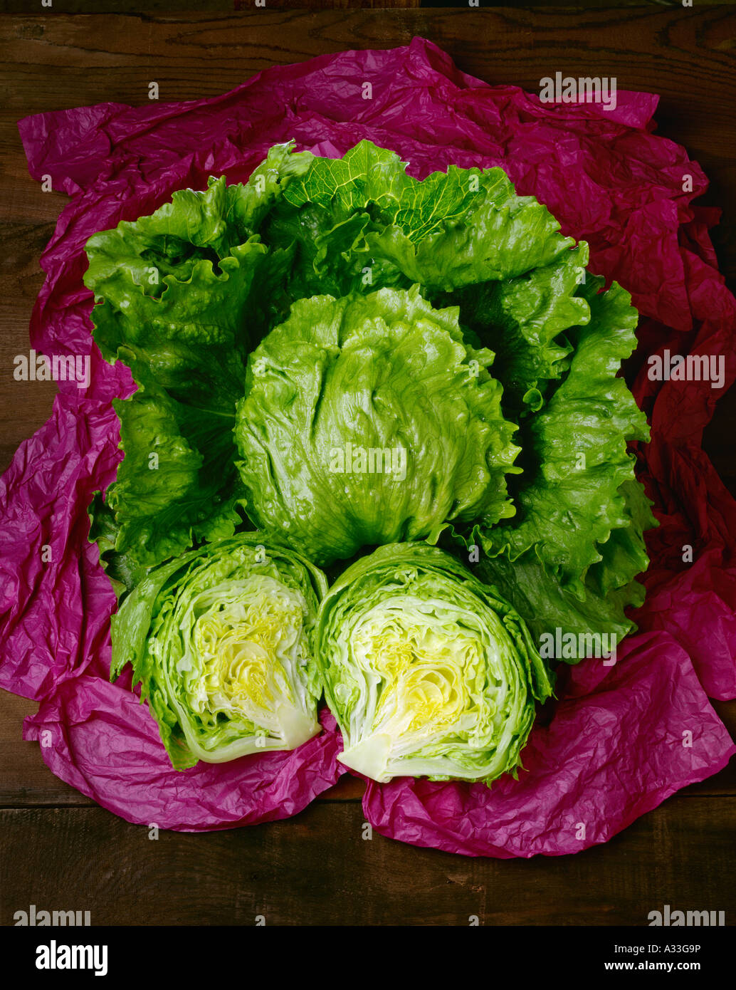 Agriculture - Iceberg lettuce heads, one cut in half, on tissue paper ...