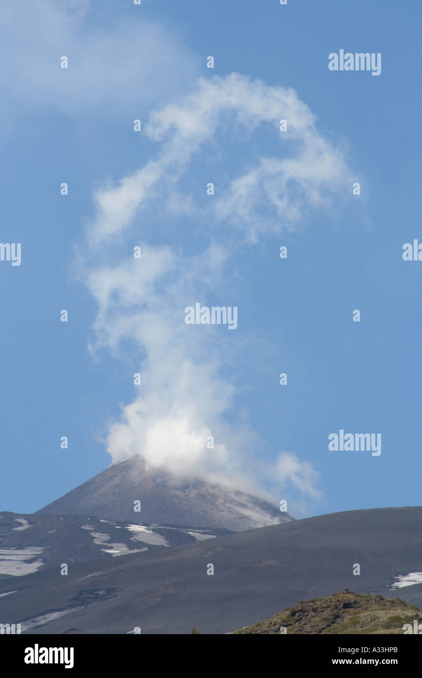 Smoke rising lazily from the central crater of volcano Mount Etna ...