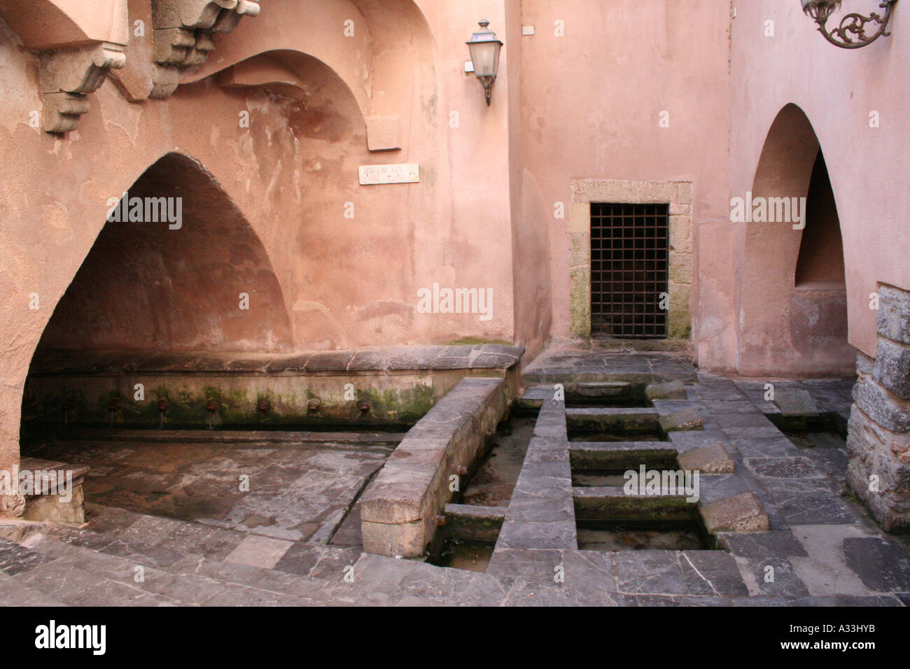 Curious old medieval washing troughs in the streets of Cefalù, Sicily ...